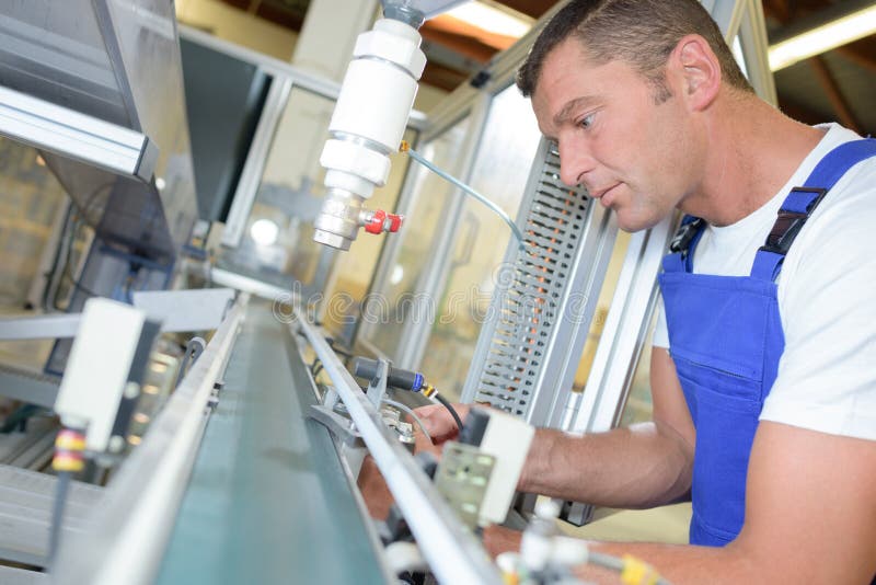 Man working on machines stock photo. Image of fixing - 188228056