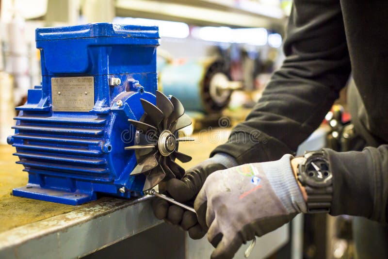Man working on machines stock image. Image of workshop - 195339039