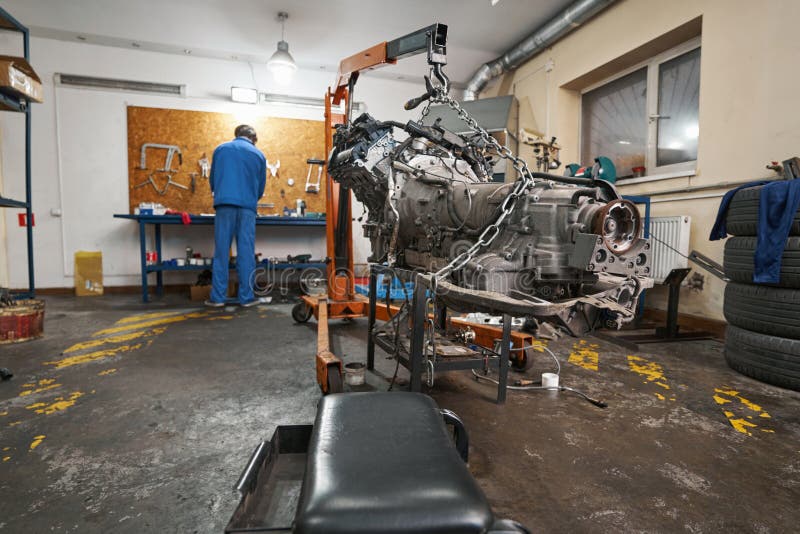 Mechanic Working Near the Table in the Garage Stock Photo - Image of ...