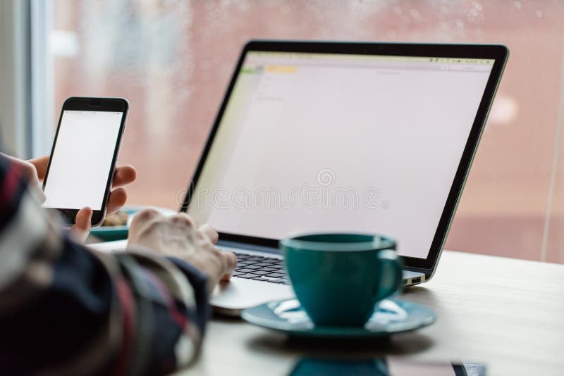 Man Working on Notebook, with a Fresh Cup of Coffee and Cell Phone ...