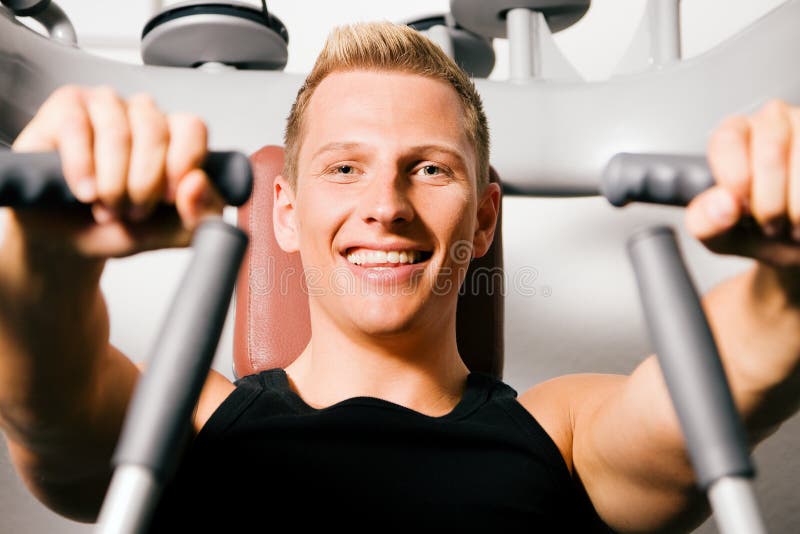 Man working out in gym stock image. Image of muscles - 12397335
