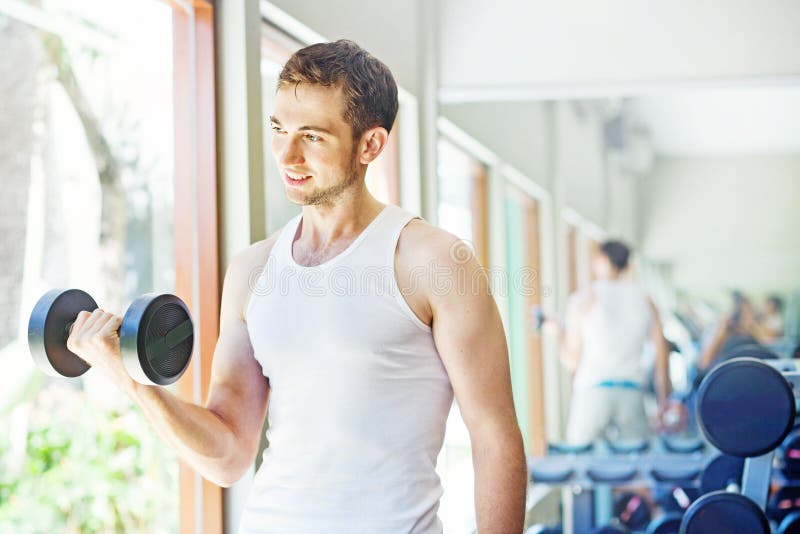 Man working out in gym stock photo. Image of happy, dumbbell - 61747664
