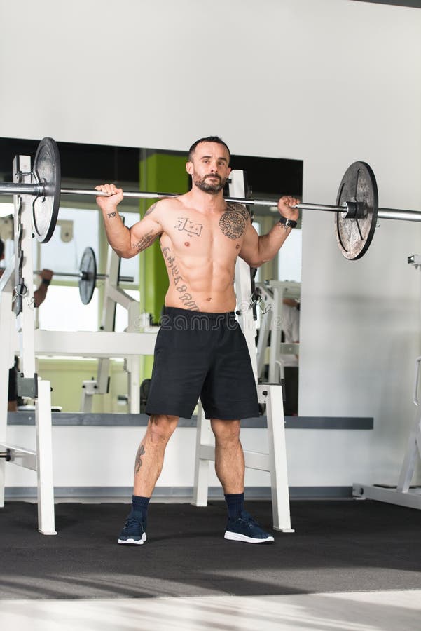 Man Doing Heavy Weight Exercise with Barbell Stock Photo - Image of ...
