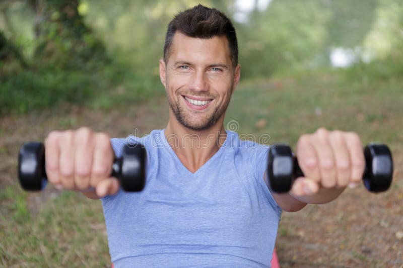 Man working out outdoors stock image. Image of dumbbell - 296716259