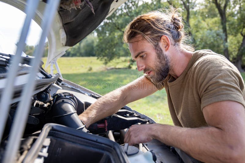Man Working Outdoors on the Engine Compartment of a Van Stock Photo ...