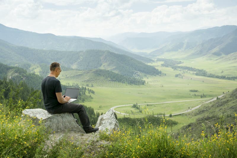 Man Working Outdoors with Laptop and Enjoying Mountain Landscape View ...