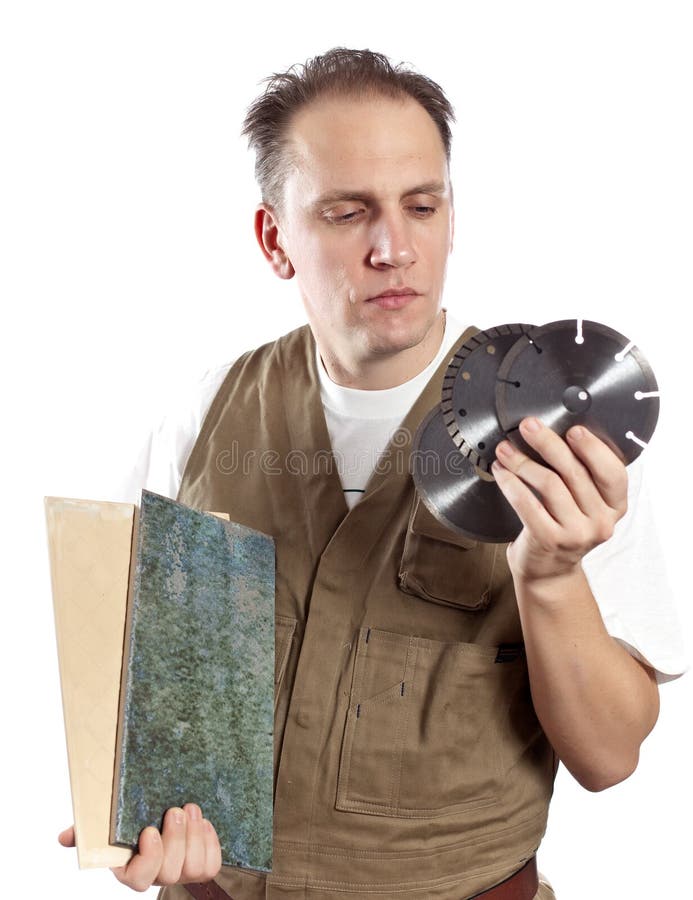 The Man In Working Overalls Chooses A Detachable Disk For The Tool ...