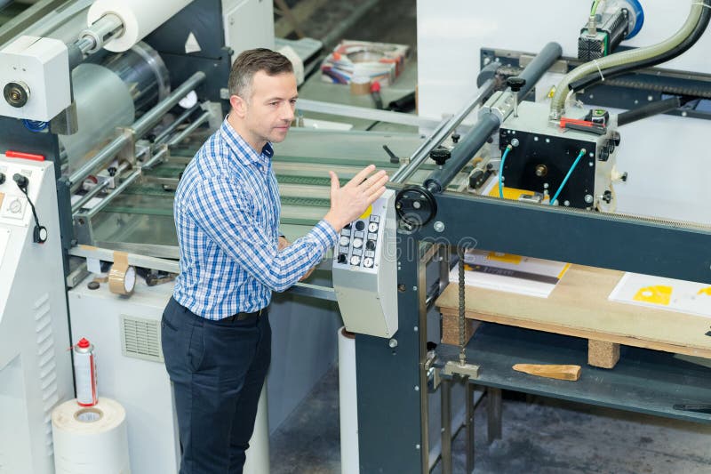 Man Working with Paper Sheets Feeling into Printing Machine Stock Image ...