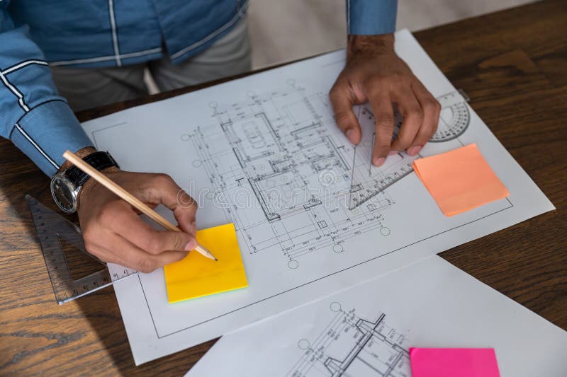 Man Working on Papers of the Construction Project Stock Image - Image ...