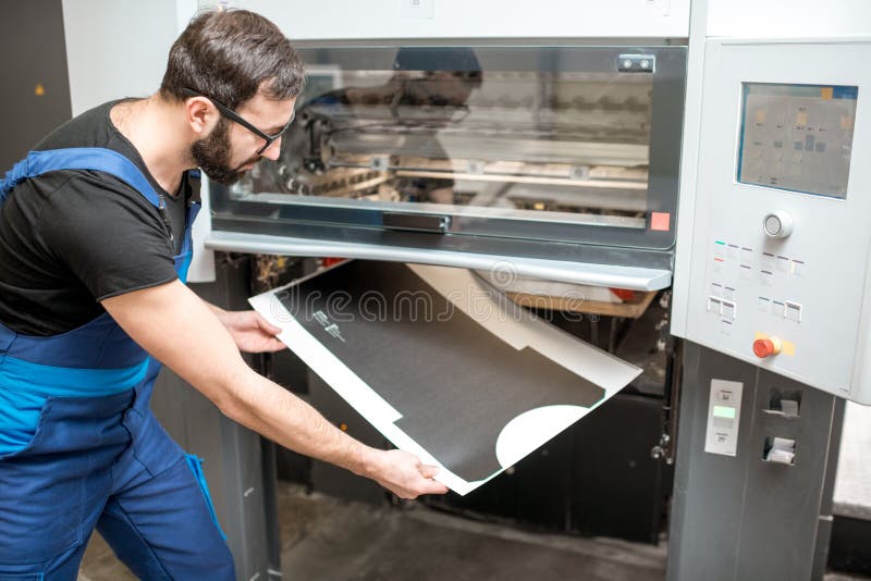 Man Working with Printing Machine at the Manufacturing Stock Photo ...
