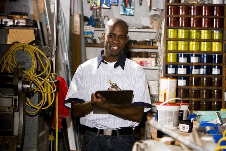 Man working in printshop stock photo. Image of african - 10707404