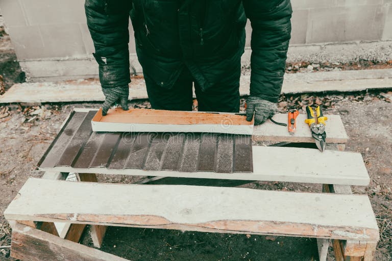 A Man is Working on a Project, Using a Saw and a Pair of Scissors Stock ...