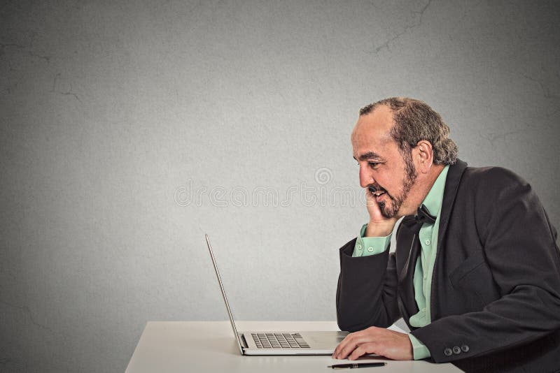 Man Working Reading Something on His Laptop Computer Stock Photo ...