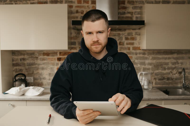A Man Working Remotely on His Tablet. a Businessman with a Beard ...