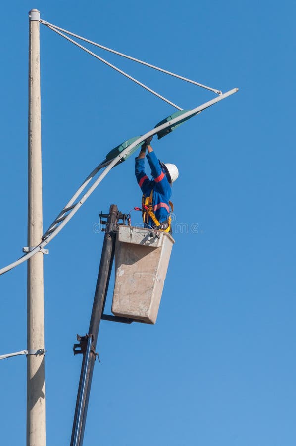 Man Working Replacing Bulb of a Lamp Post. Stock Image - Image of ...