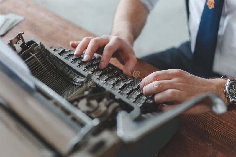 Man Working on Retro Typewriter at Desk in Parlor Room Stock Image ...