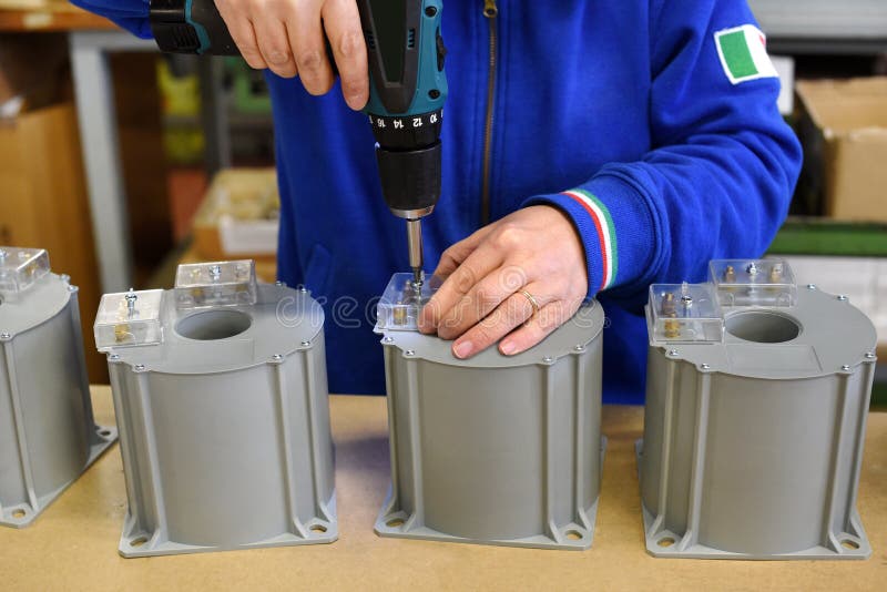 Man Working with Gun at Assembly Line Stock Photo - Image of ...
