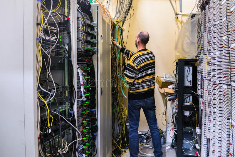 An Engineer Connects Magistral Optical Fiber Wires. a Man Commutes ...