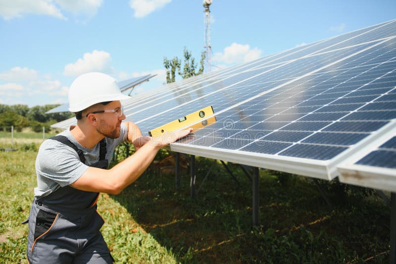 A Man Working at Solar Power Station. Stock Image - Image of green ...