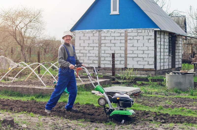 Man Working in the Spring Garden with Tiller Machine Stock Photo ...