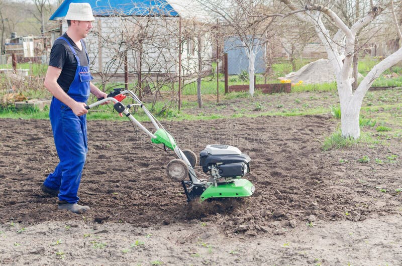 Man Working in the Spring Garden with Tiller Machine Stock Photo ...