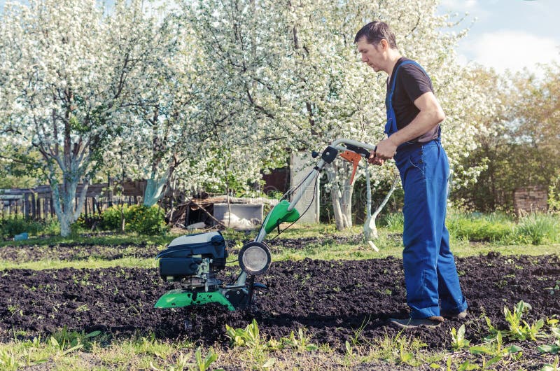 Man Working in the Spring Garden with Tiller Machine Stock Photo ...
