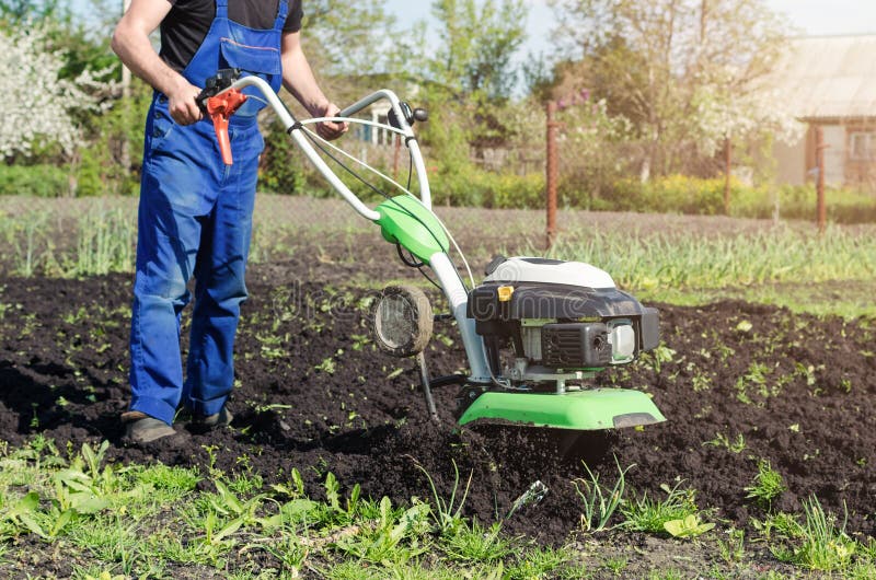 Man Working in the Spring Garden with Tiller Machine Stock Photo ...