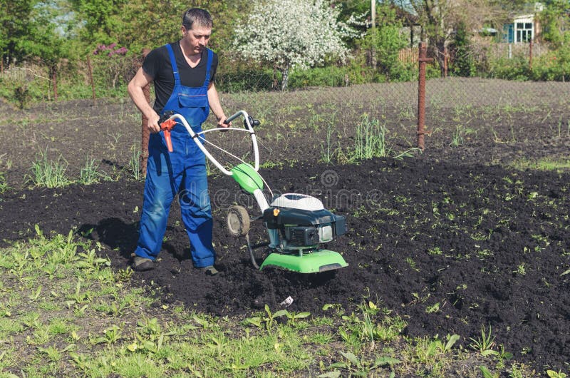 Man Working in the Spring Garden with Tiller Machine Stock Image ...