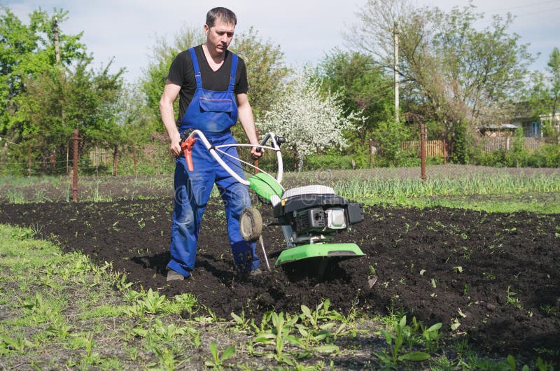 Man Working in the Spring Garden with Tiller Machine Stock Photo ...
