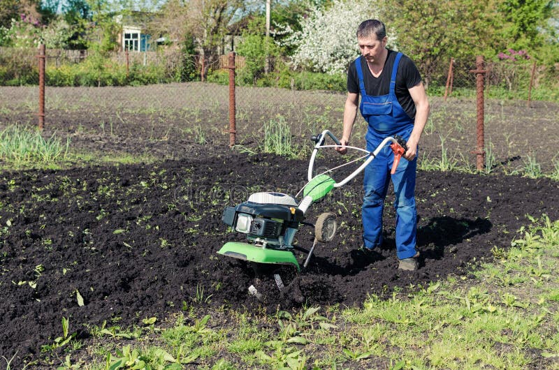 Man Working in the Spring Garden with Tiller Machine Stock Photo ...