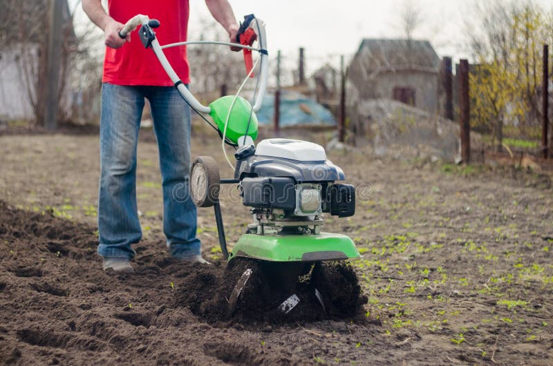 Man Working in the Spring Garden with Tiller Machine Stock Image ...