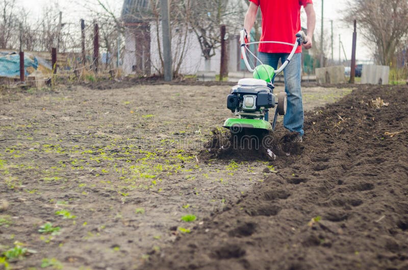 Man Working in the Spring Garden with Tiller Machine Stock Photo ...
