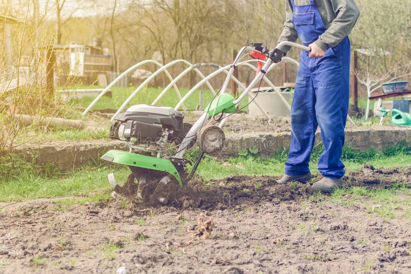 Man Working in the Spring Garden with Tiller Machine Stock Photo ...