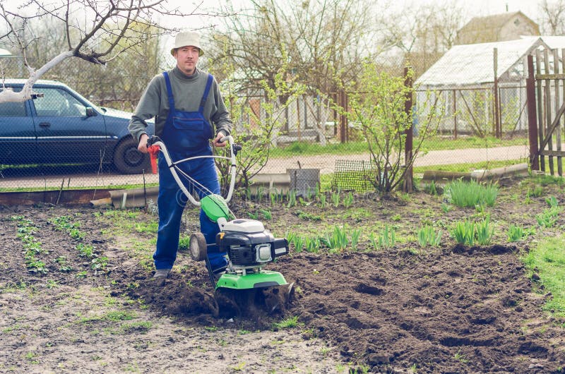 Man Working in the Spring Garden with Tiller Machine Stock Image ...