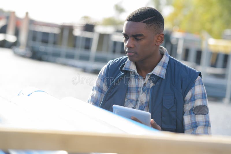 Man working with tablet stock photo. Image of outdoors - 258969142