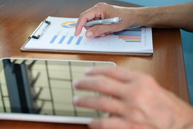 Man Working with Tablet at Office. Businessman Analyzing Chart D Stock ...