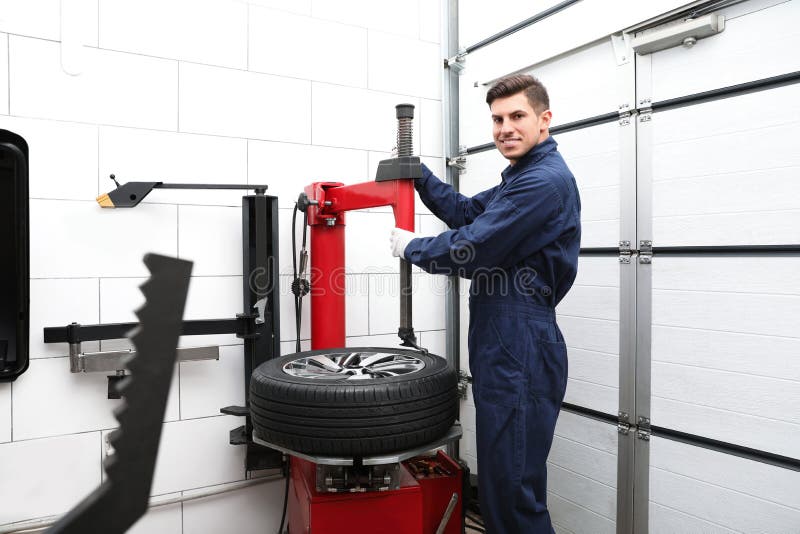 Man Working with Tire Fitting Machine at Service Stock Photo - Image of ...
