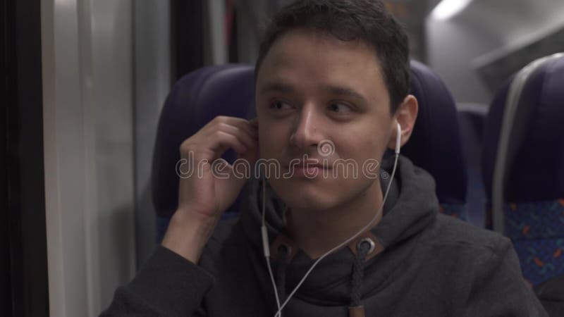 Young Man Working on a Train and Having Fun with a Smartphone and ...
