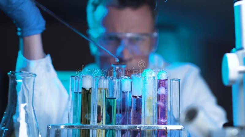 Man working with tubes stock image. Image of researcher - 95590113