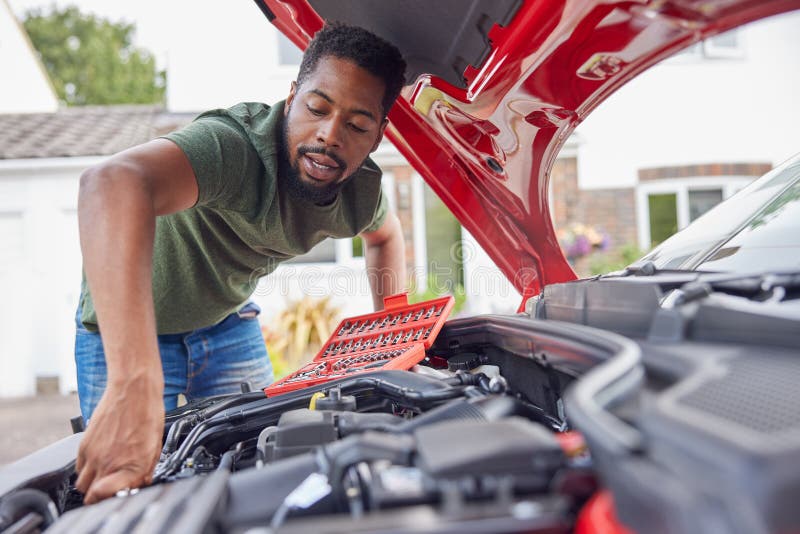 Man Working Under Hood of Car Fixing Engine with Wrench Stock Photo ...