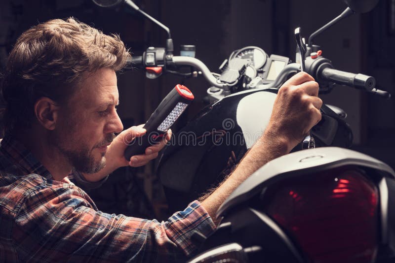 Man Working on a Vintage Motorcycle in a Workshop Stock Photo - Image ...