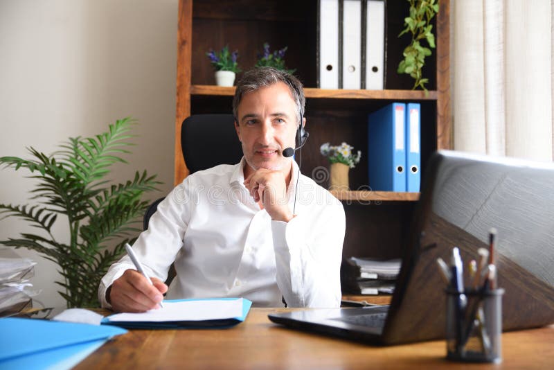 Man Working Virtually Taking Notes in Online Meeting Stock Image ...