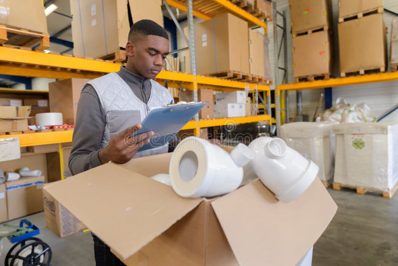 Man working in warehouse stock image. Image of sitting - 173508719