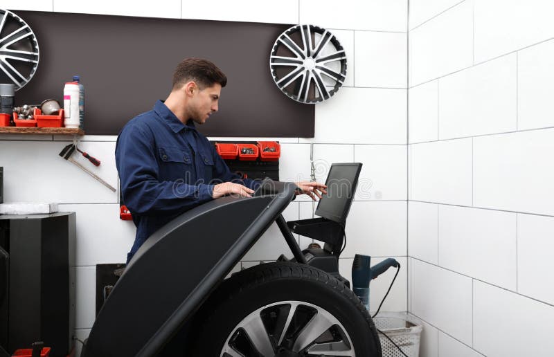 Man Working with Wheel Balancing Machine at Service Stock Image - Image ...