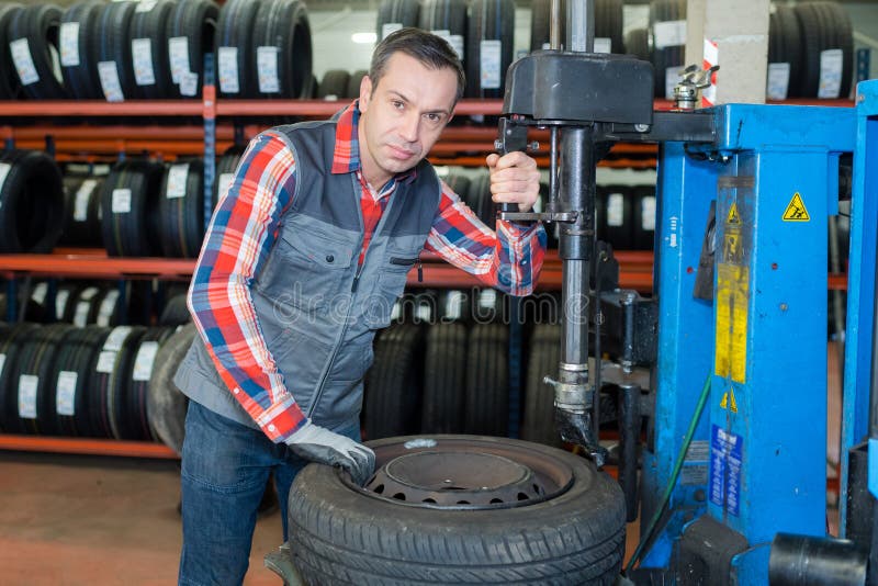 Man Working with Wheel Indoors Stock Photo - Image of mechanic, hands ...