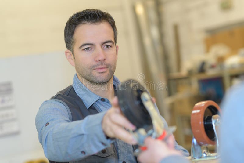 Man working with wheels stock image. Image of precision - 123594315