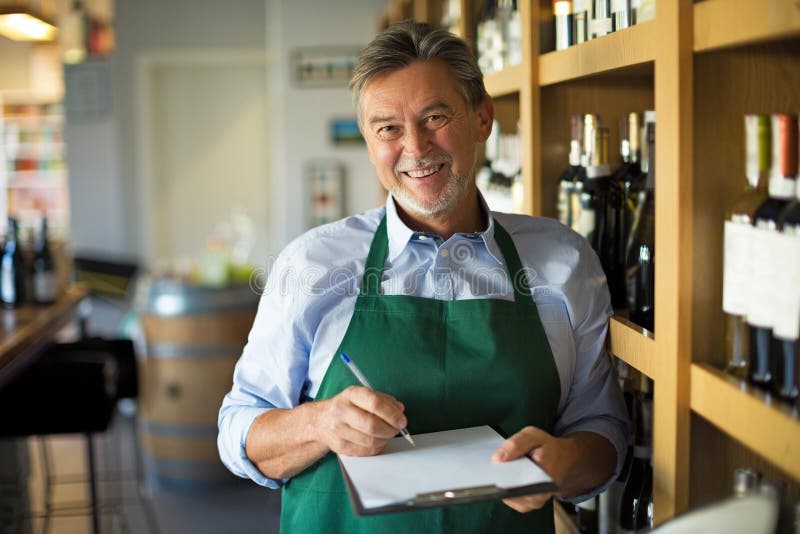 Man working in wine shop stock photo. Image of entrepreneur - 79358340