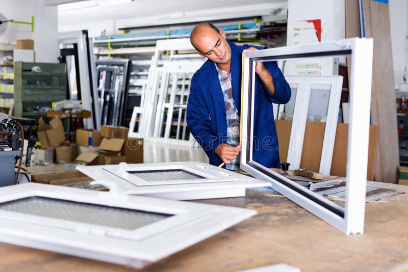 Man Working in Workshop for Assembling Plastic Windows Stock Image ...