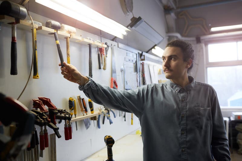 Man working in workshop stock photo. Image of portrait - 168268516