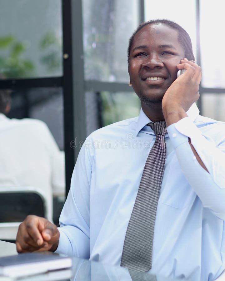 A Man at a Workplace at a Table in Front of a Computer Speaks on the ...